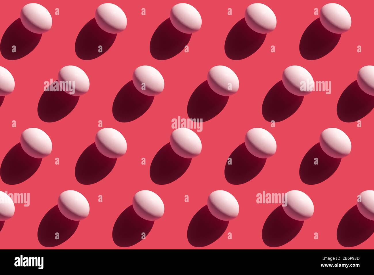 Repeating white eggs with a hard shadow on a pink background, easter ...
