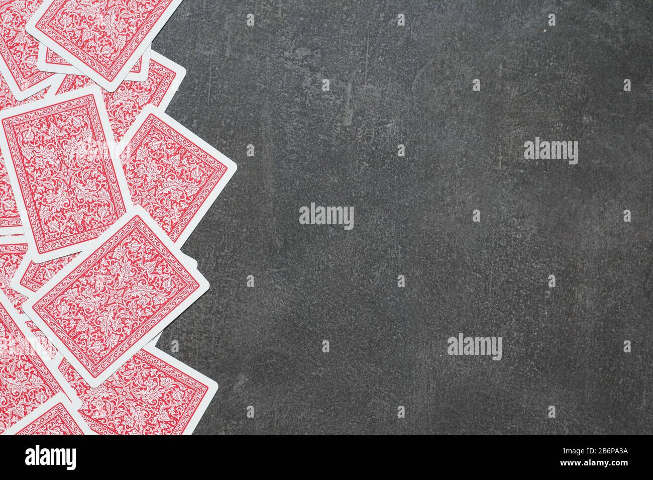 Background of various scattered playing cards face down. Copy space ...