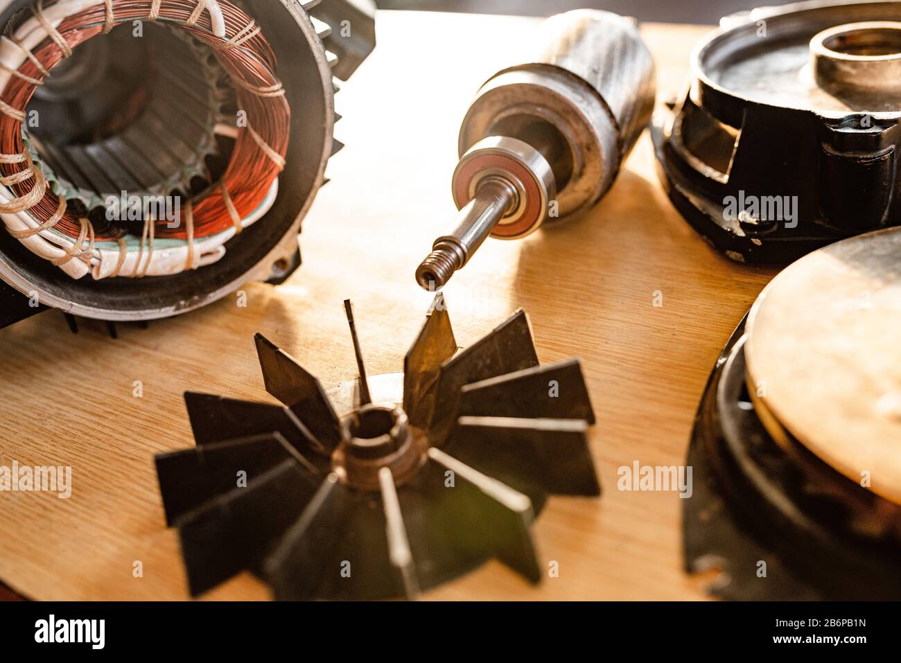 Close-up of a disassembled metal motor with wire and plugs lies on a ...