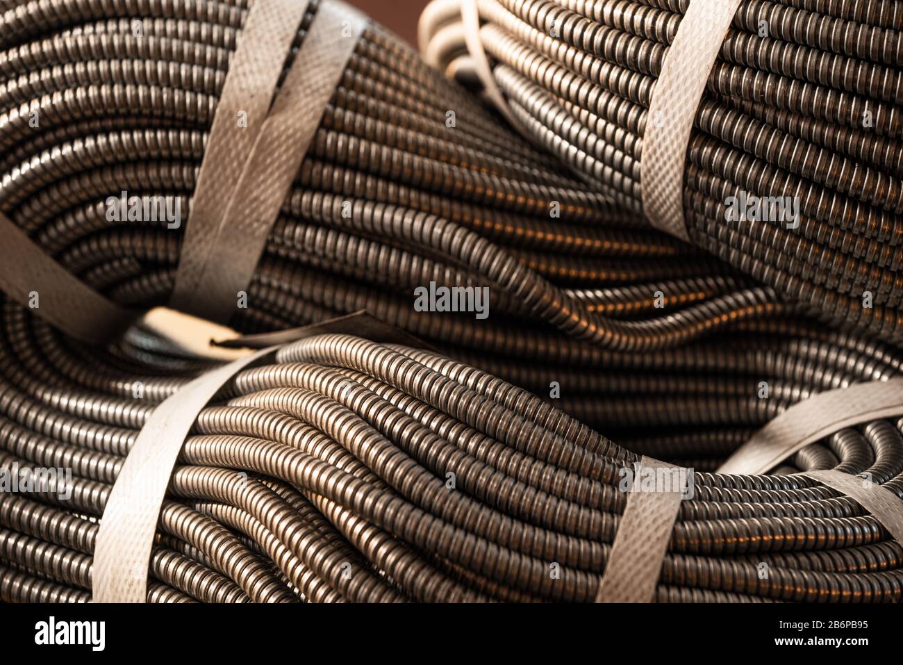 Close-up of a huge golden bundle of metal flexible tubes interconnected ...