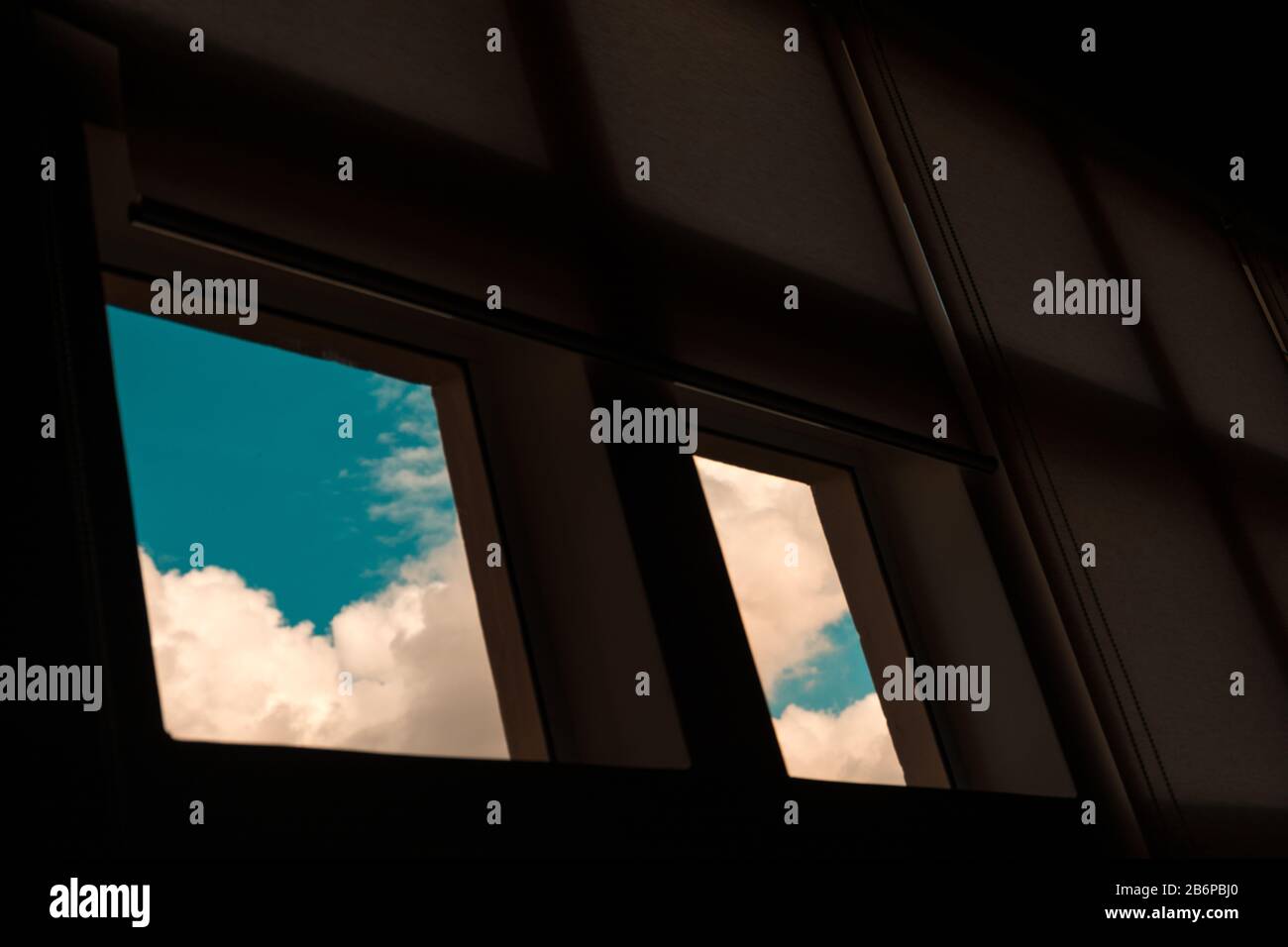 Square windows that shows a clear blue sky at the outside, during a ...