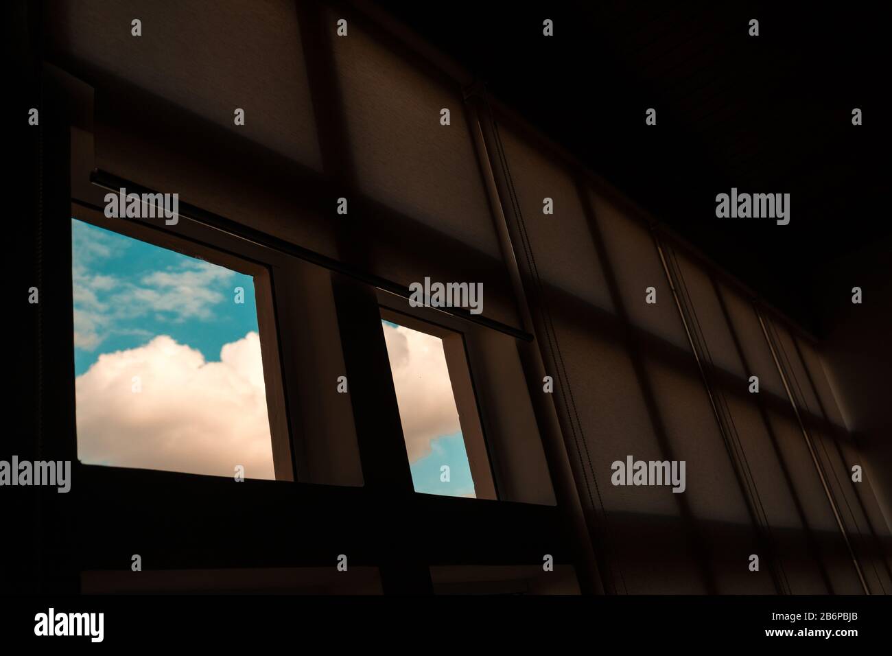 Square windows that shows a clear blue sky at the outside, during a ...