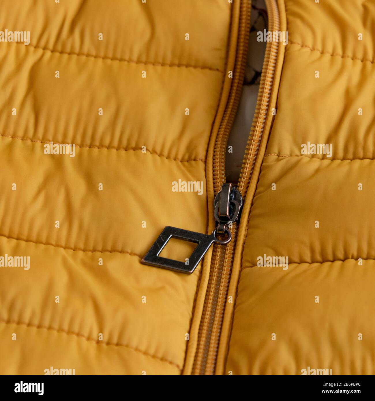 Crop view of yellow down jacket Stock Photo - Alamy