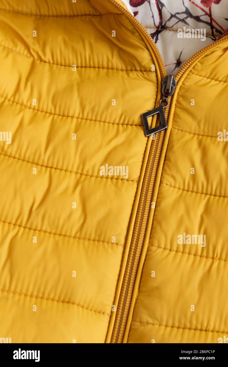 Crop view of yellow down jacket Stock Photo - Alamy