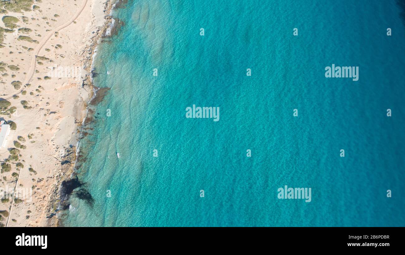 turquoise sea beach with rocks and vegetation from a bird's eye view on ...