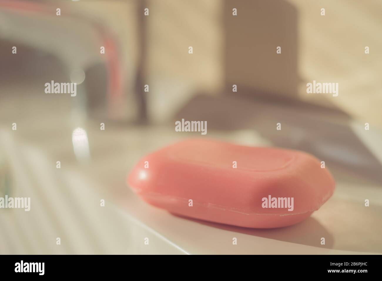 Pink bar of soap on the sink in the bathroom. Side view close up Stock ...