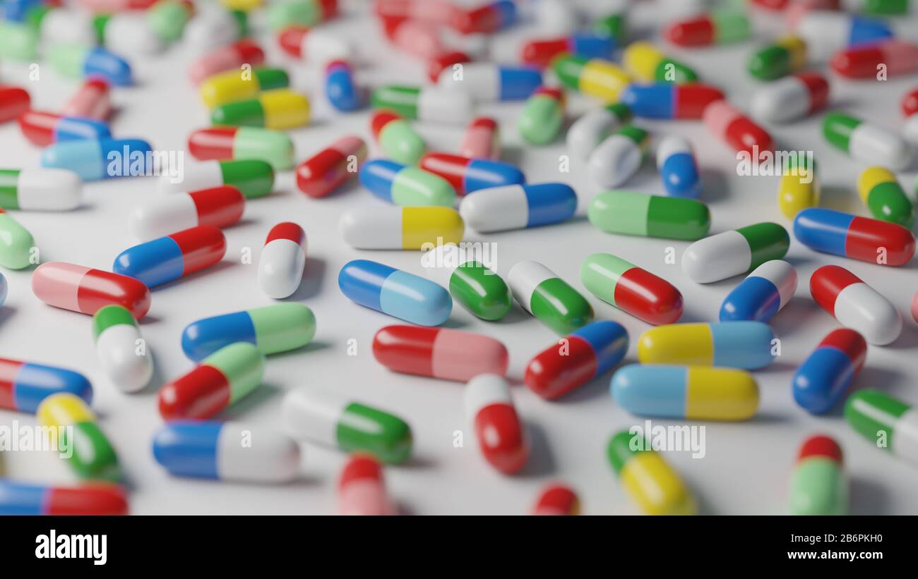 Multicolored pills on white background. Medical treatment ...