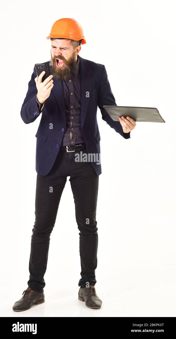 Brutal man wears helmet. Inspector holds documents and talks on phone ...