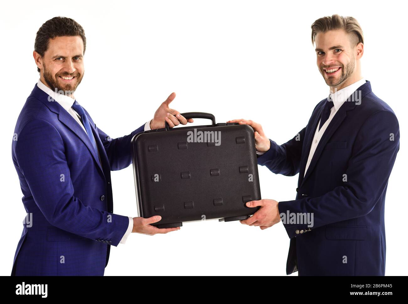 Handover of suitcase in hands of partners on white background ...
