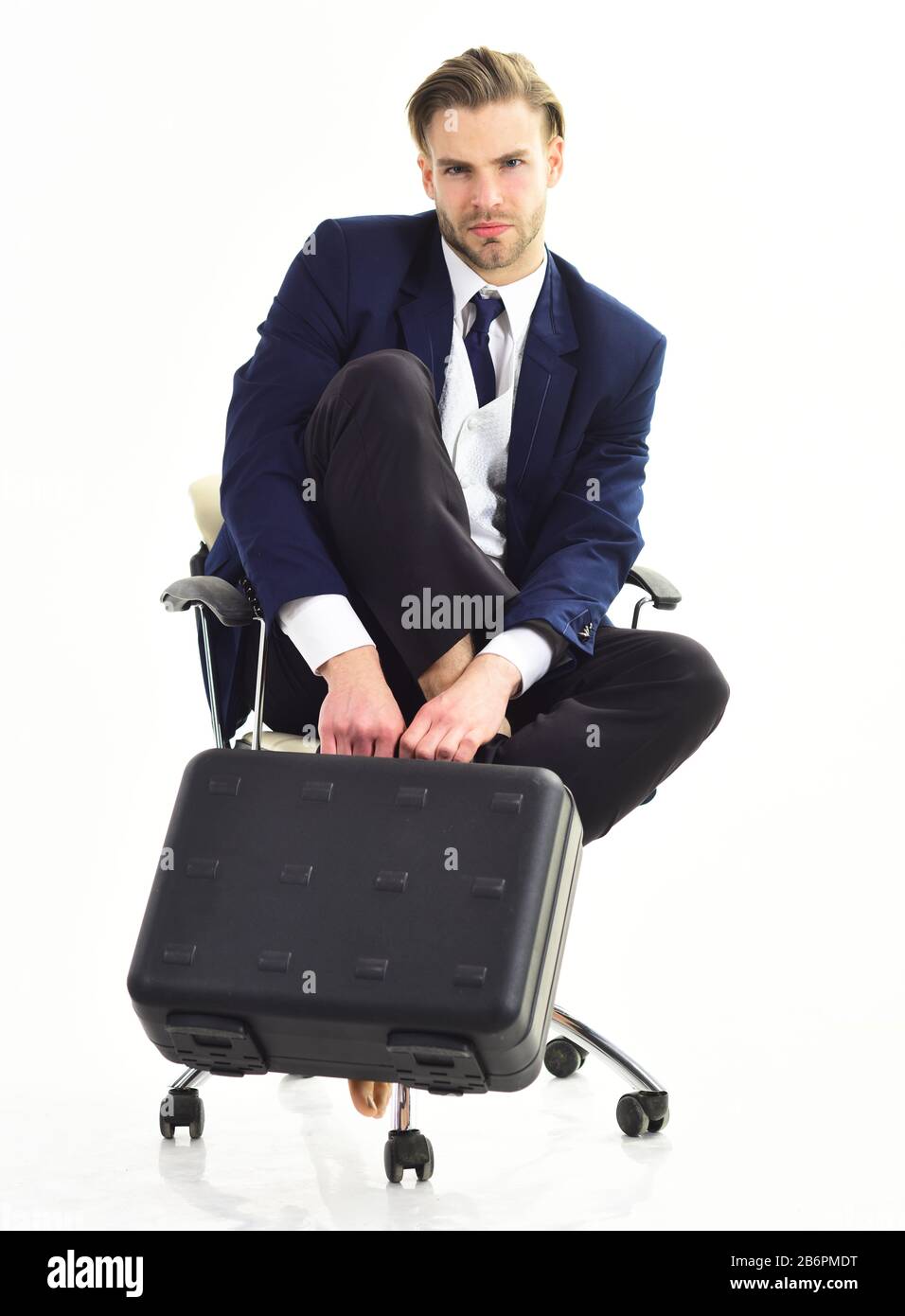 Bearded man holding case with bomb. Terrorist in office suit sits with ...
