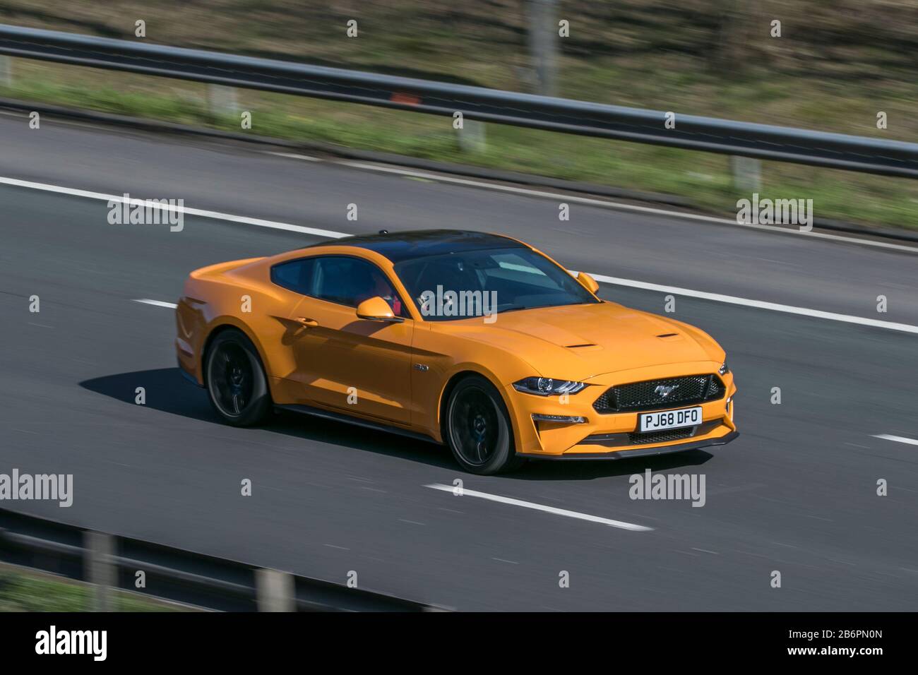 PJ68DFO Ford Mustang Gt Orange Car Petrol driving on the M6 motorway ...
