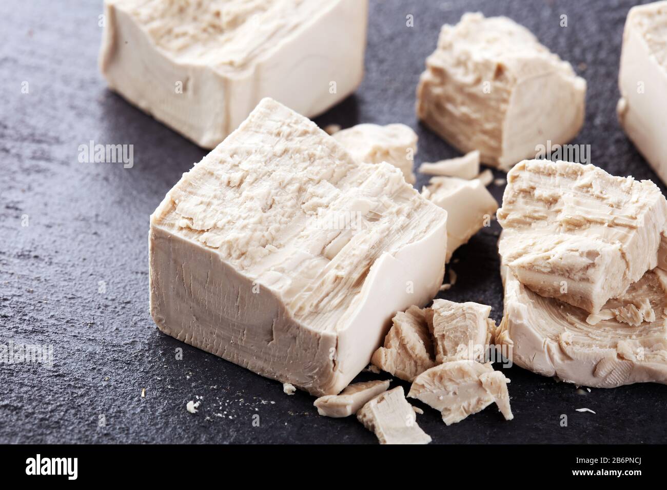 Dry yeast crumbled and yeast block for baking on table Stock Photo - Alamy