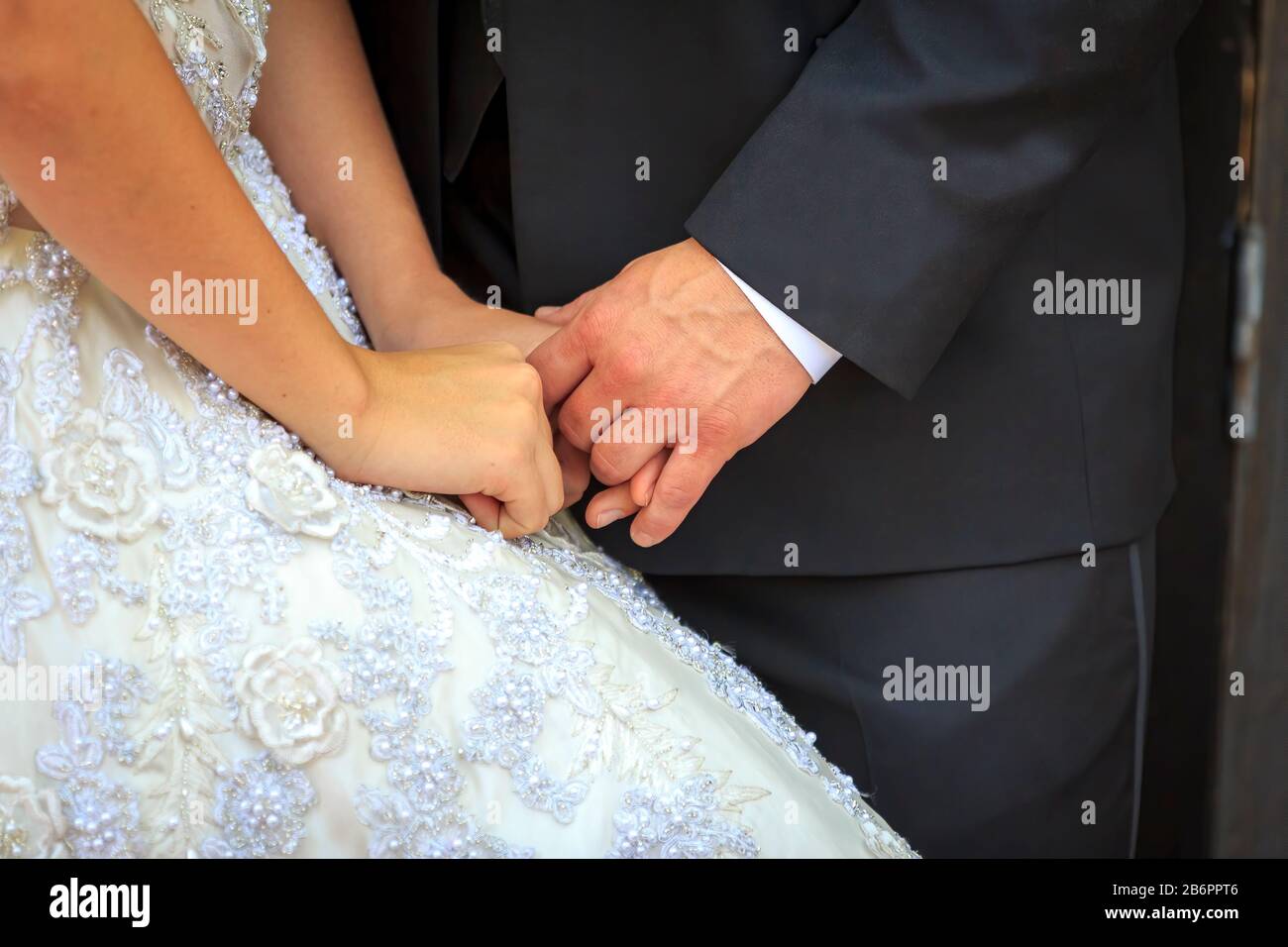 Hand holding bride and groom on the day of their wedding Stock Photo ...