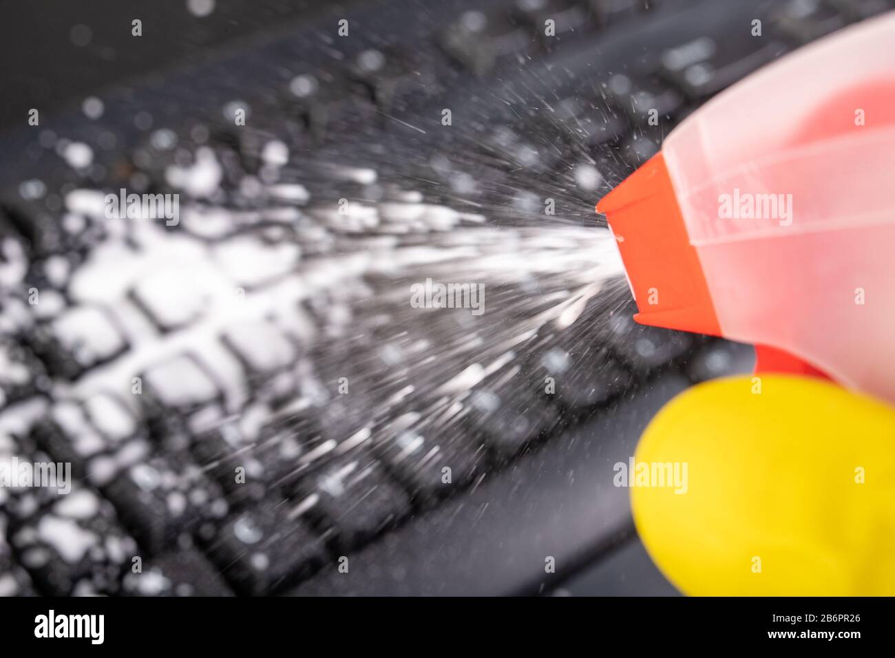 Cleaning the keyboard from dust and dirt with disinfectant. Maintenance ...