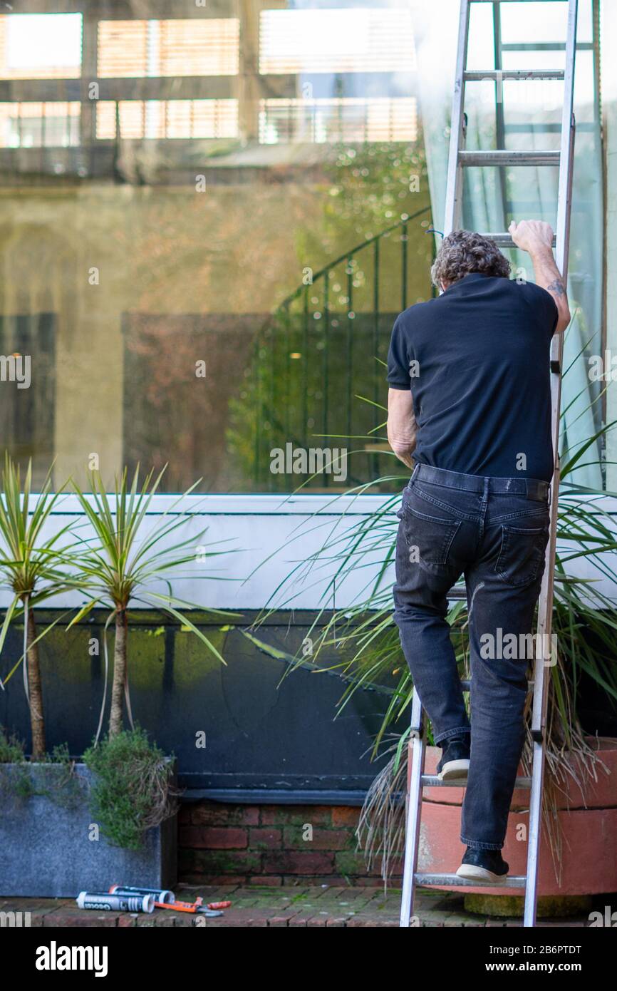 Working up a ladder hi-res stock photography and images - Alamy