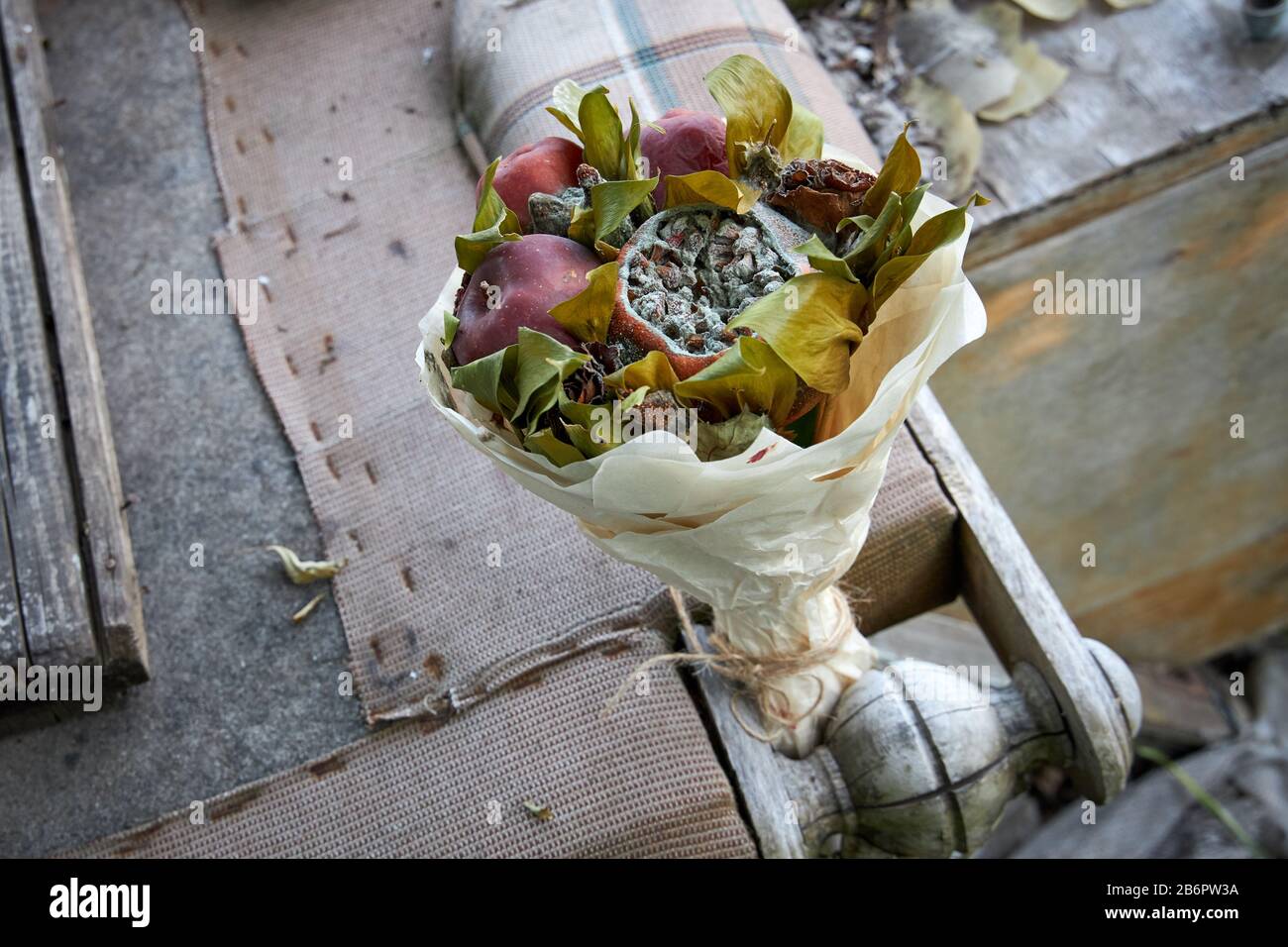 Bunch of rotten fruit and wilted flowers and broken old furniture of a ...
