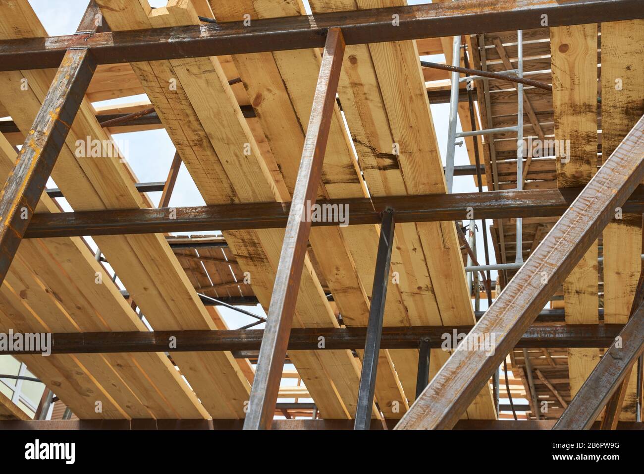 Metal frame of a building under construction with wooden floor Stock ...