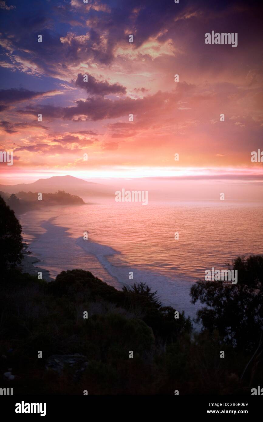 Sunset over a remote beach Stock Photo - Alamy