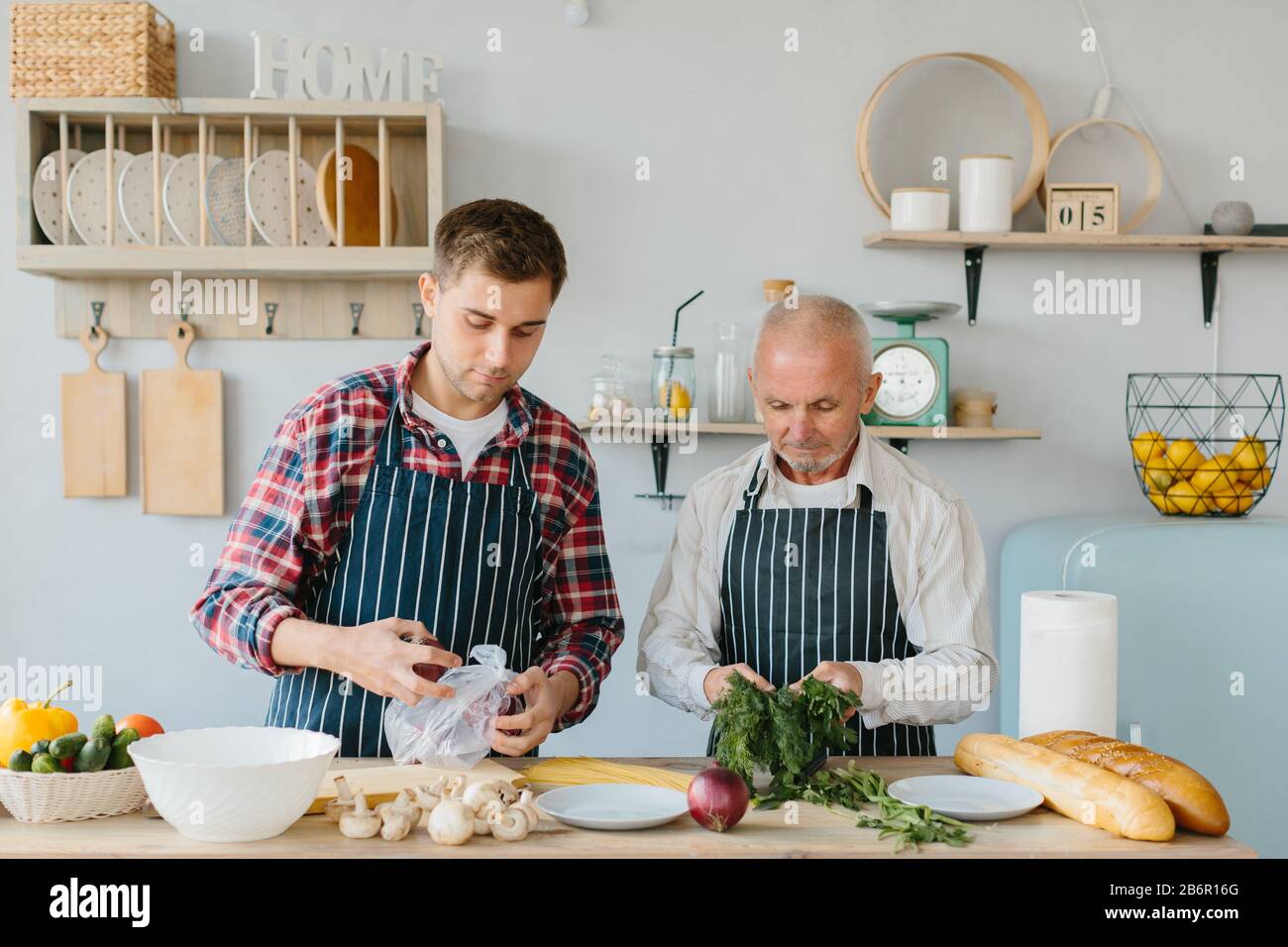 Son with his senior father cooking in the kitchen Stock Photo - Alamy