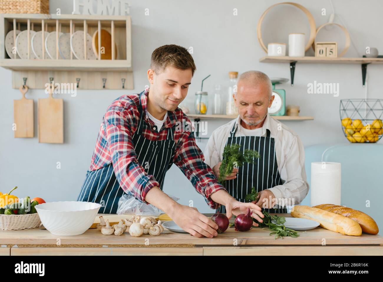 Son with his senior father cooking in the kitchen Stock Photo - Alamy