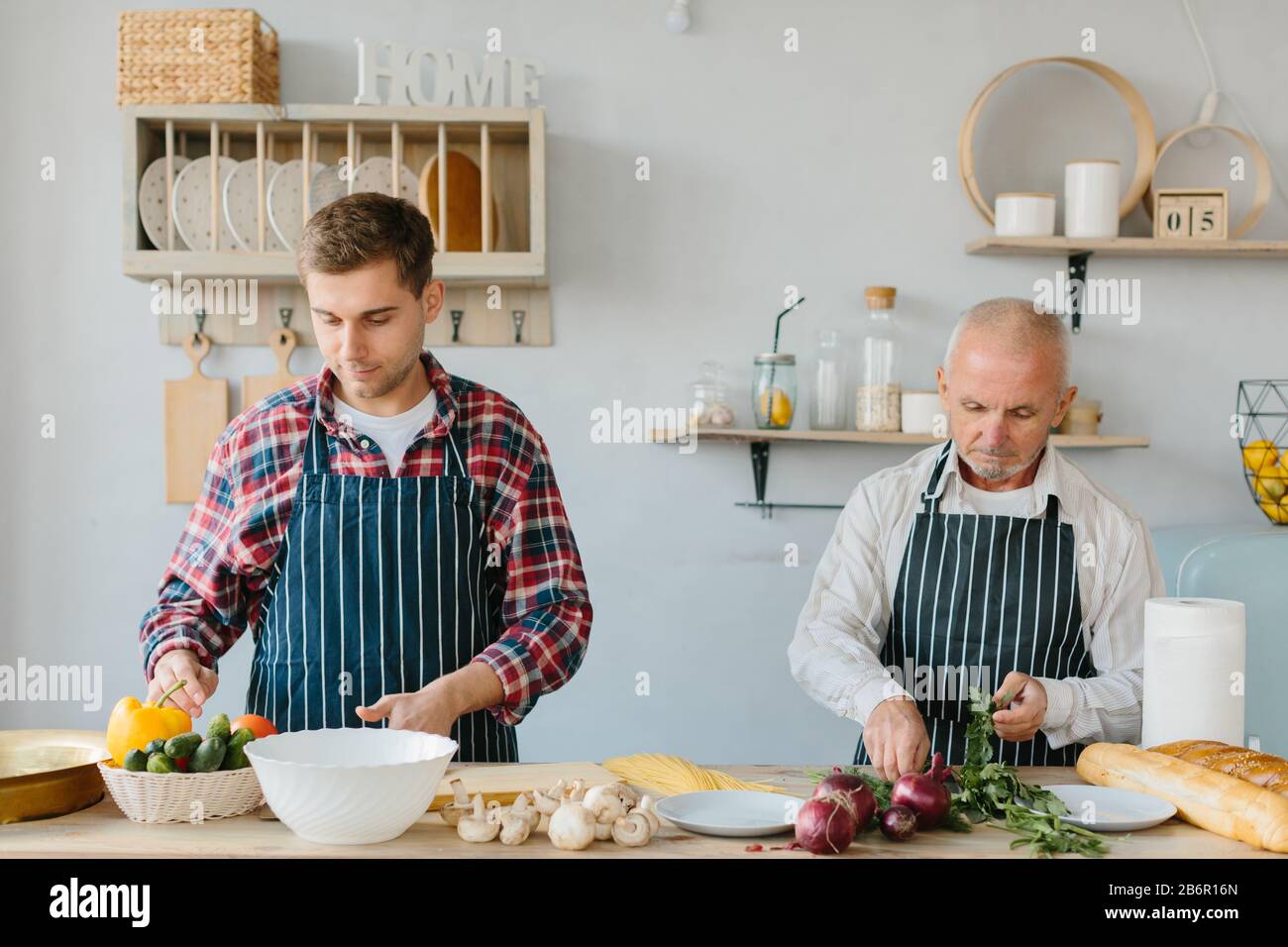 Son with his senior father cooking in the kitchen Stock Photo - Alamy