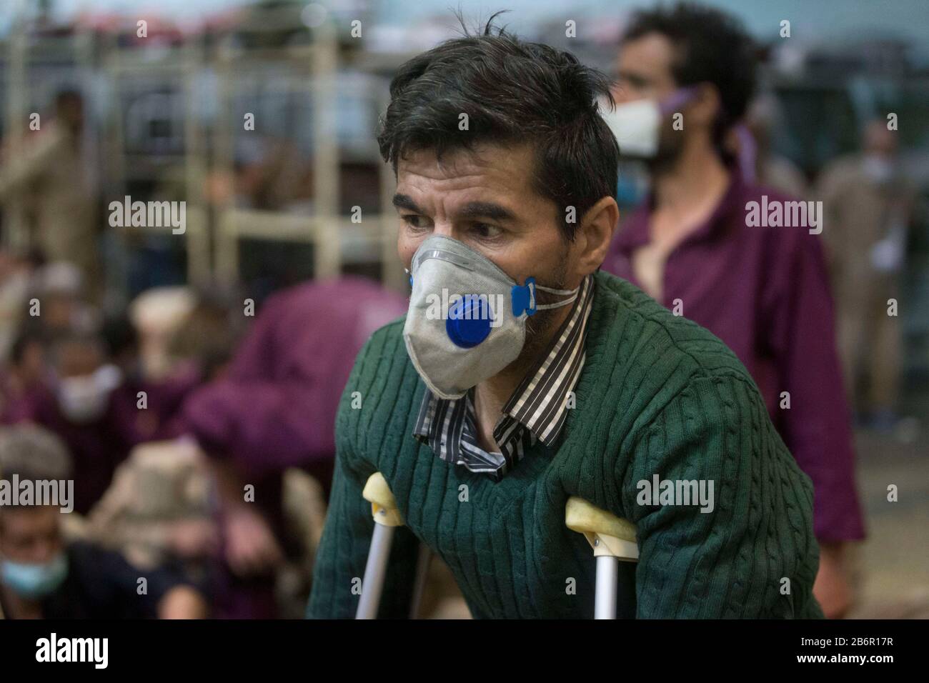 Tehran, Iran. 10th Mar, 2020. Homeless men wearing face protective ...