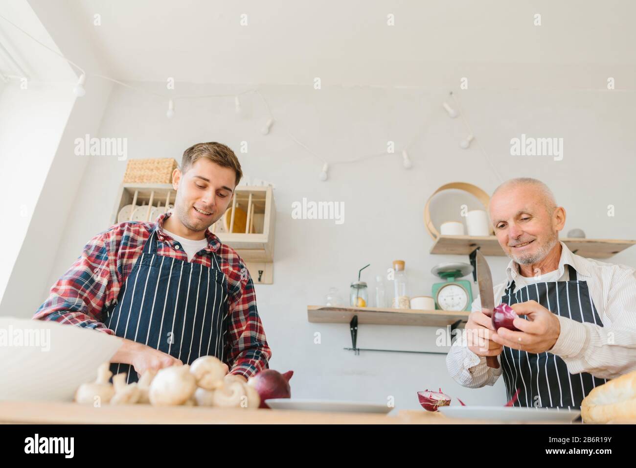 Son with his senior father cooking in the kitchen Stock Photo - Alamy
