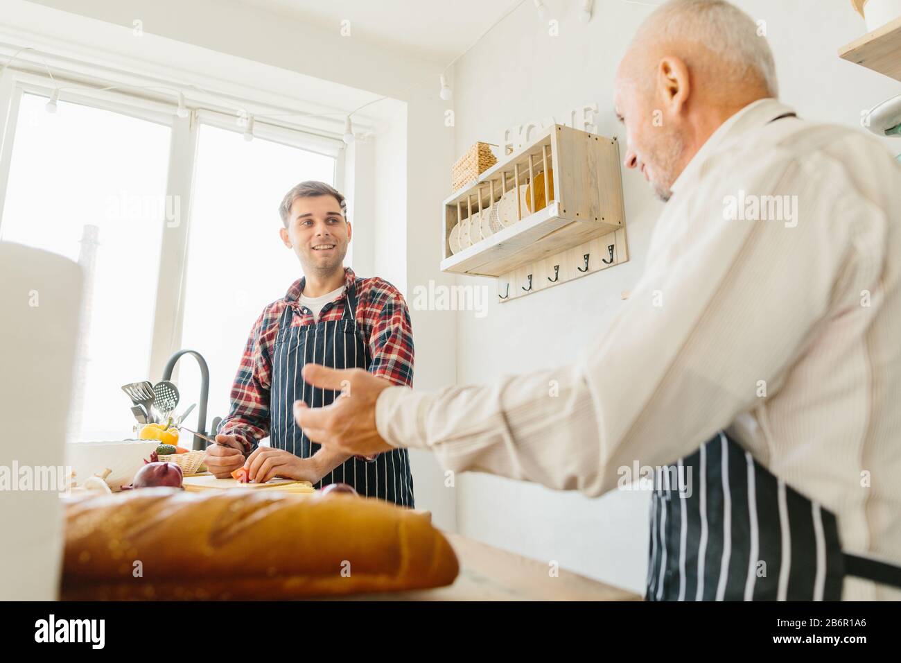 Son with his senior father cooking in the kitchen Stock Photo - Alamy