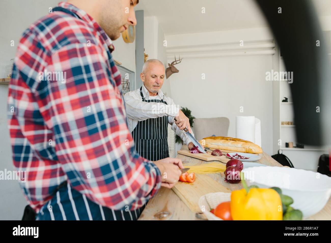 Son with his senior father cooking in the kitchen Stock Photo - Alamy