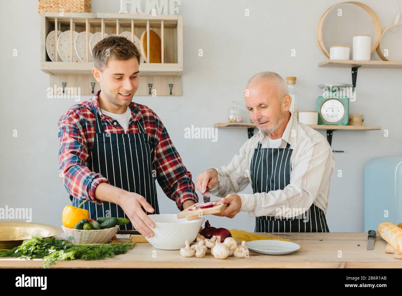 Son with his senior father cooking in the kitchen Stock Photo - Alamy