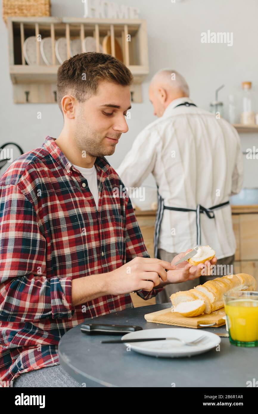 Son with his senior father cooking in the kitchen Stock Photo - Alamy