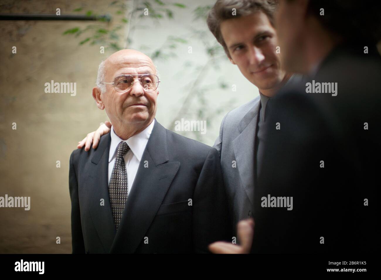 Three men are involved in an animated conversation Stock Photo - Alamy