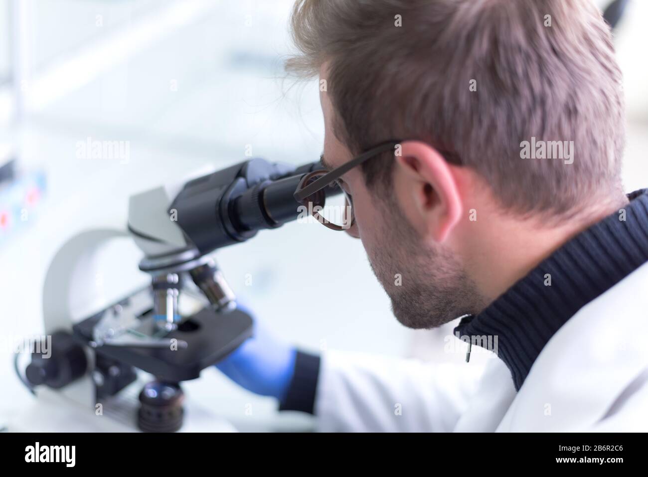 Microbiologist with a tube of biological sample contaminated by ...