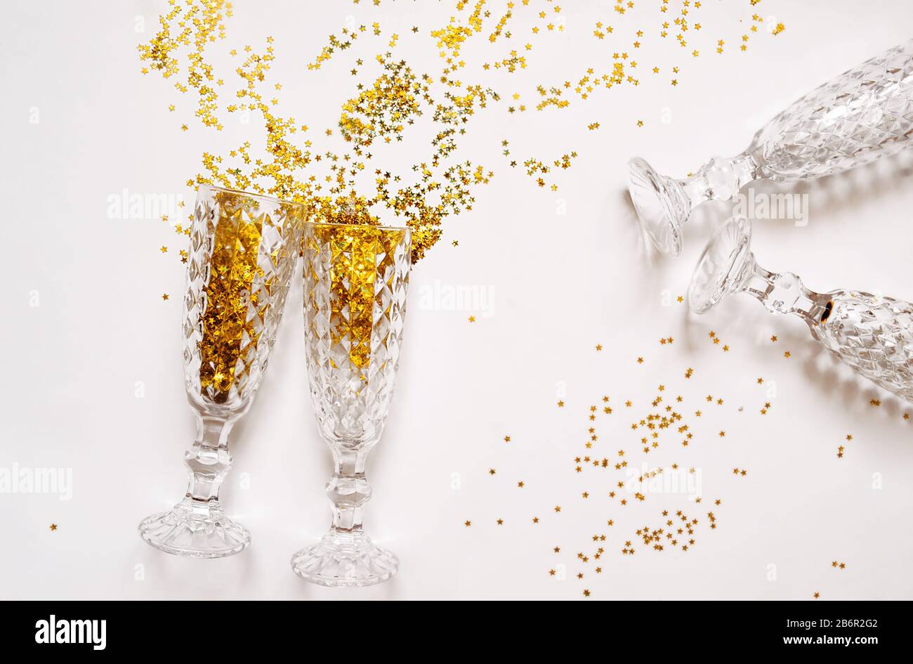 Splashes of gold spangles of stars from a glass figurative glass on a ...