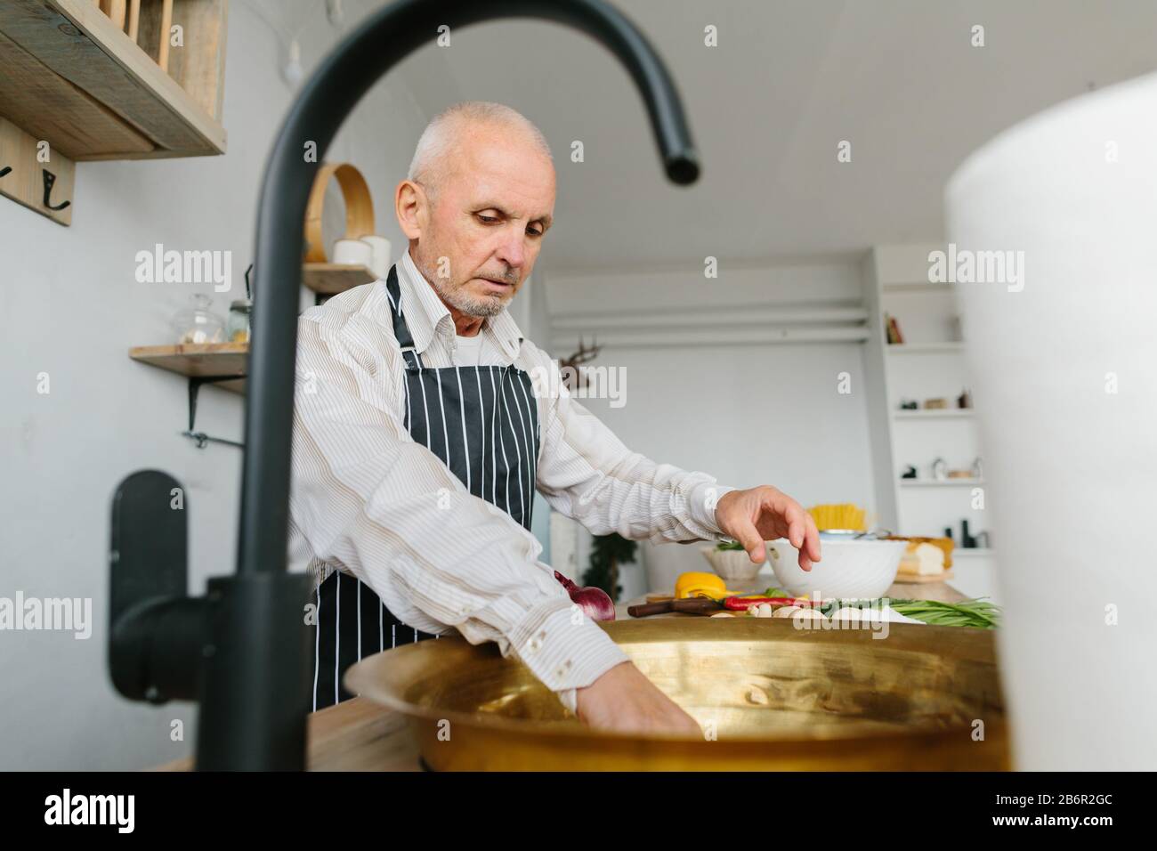 Senior father was washing mushrooms in the kitchen Stock Photo - Alamy