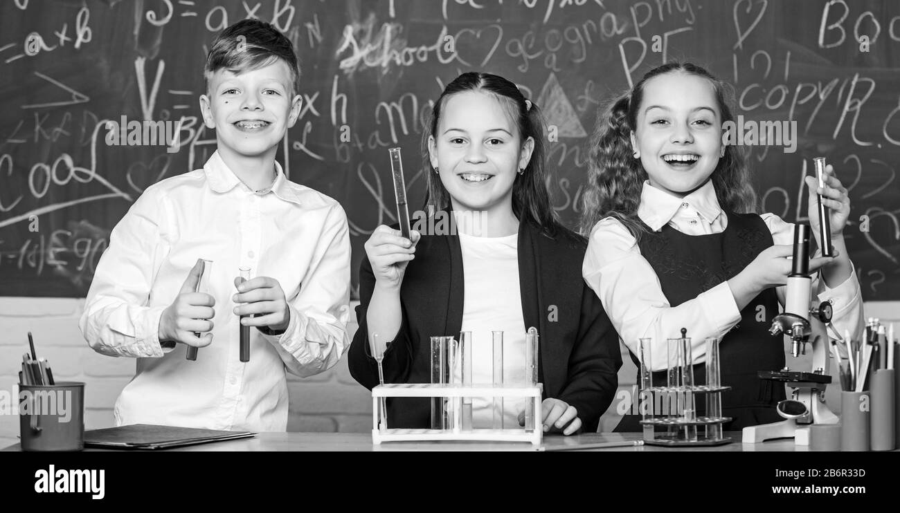 Girls and boy student conduct school experiment with liquids. Check ...