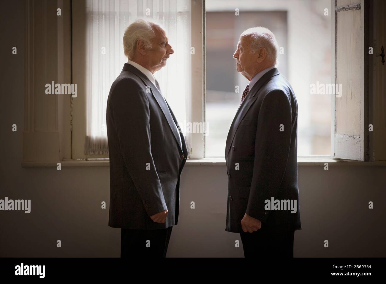 View of two senior men looking face to face Stock Photo - Alamy