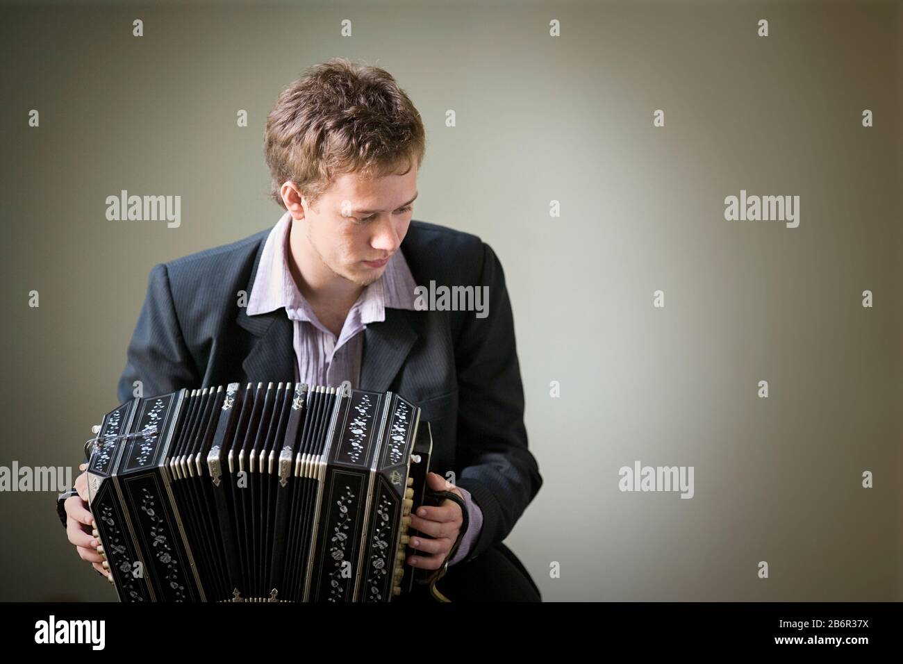 View of a young adult playing accordion Stock Photo - Alamy