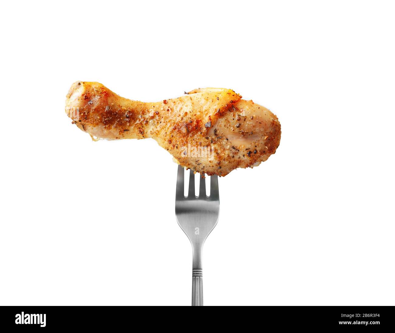 Baked chicken drumstick on a fork isolated on white background Stock ...