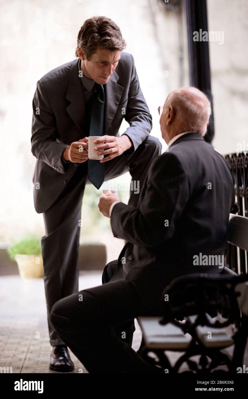 Side view of two men engaged in a conversation Stock Photo - Alamy