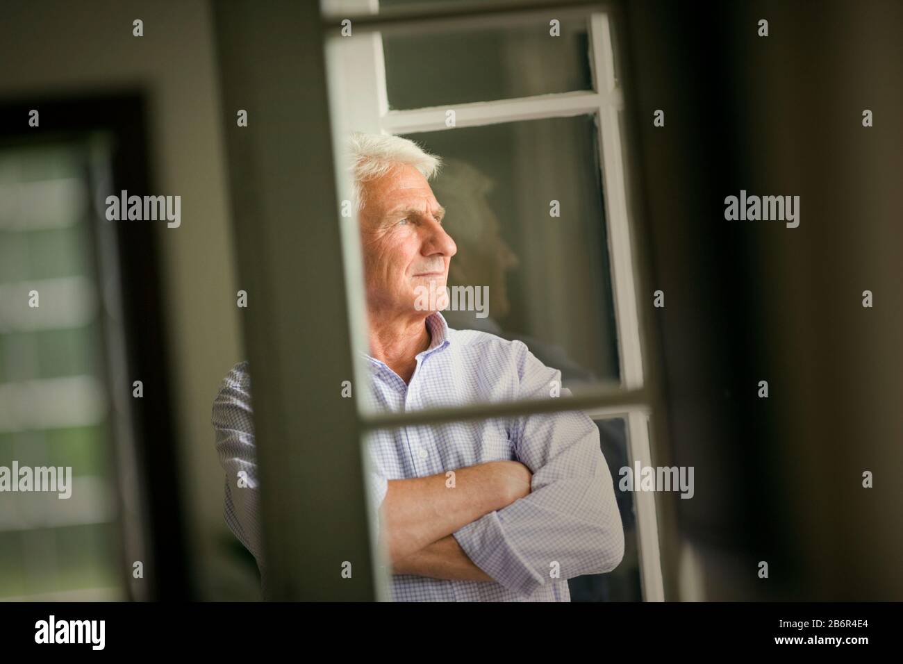 View of a sad man standing at a doorway Stock Photo - Alamy