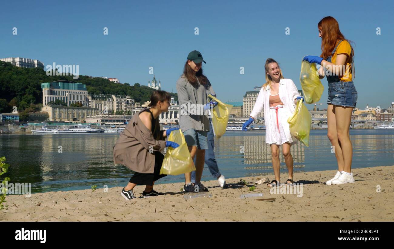 Group of activists friends collecting plastic waste on the beach ...