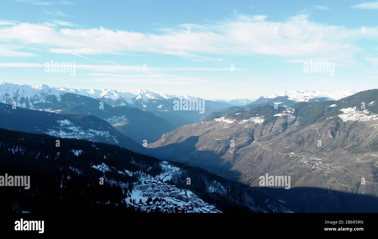 Aerial winter scene of alpine snowy mountain peaks and dark spruce ...