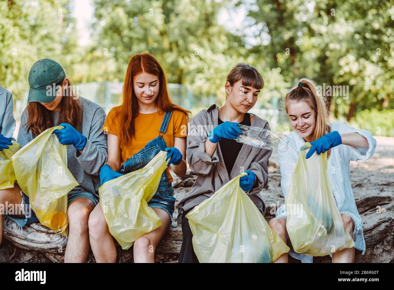 Group of activists friends collecting plastic waste at the park ...