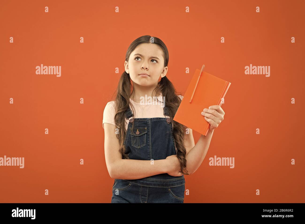 school girl read book on orange background. writing notes. kid diary ...