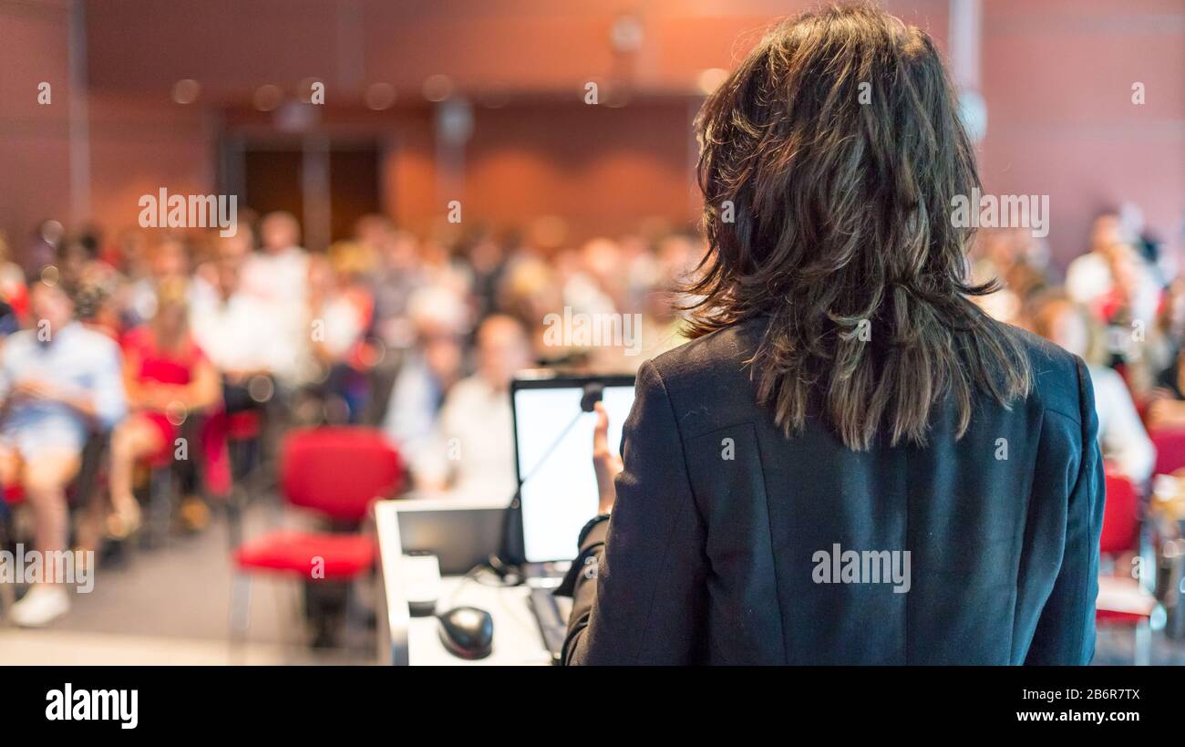 Female public speaker giving talk at Business Event Stock Photo - Alamy