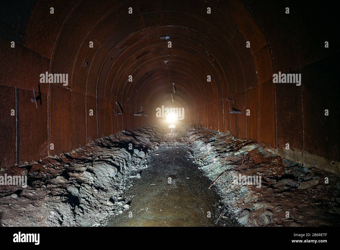 Light at the end of dirty sewer tunnel Stock Photo - Alamy