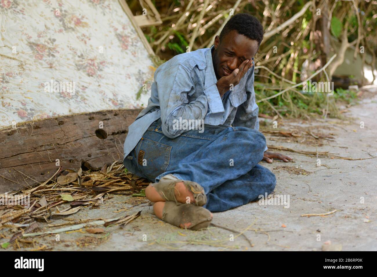 Sad young homeless African man crying in the streets Stock Photo - Alamy