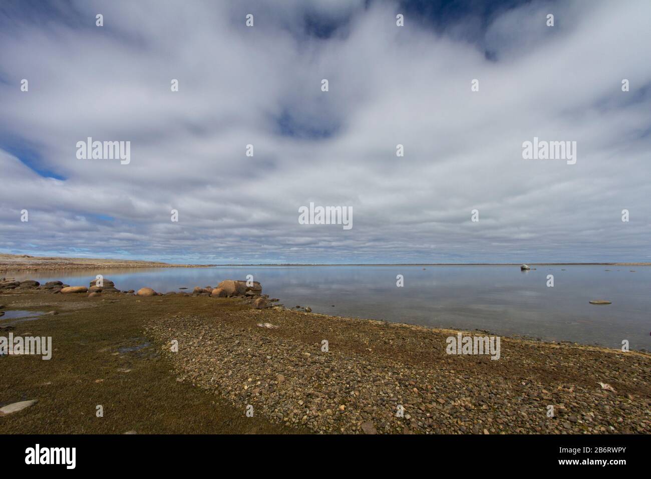 Flat arctic landscape and lake in the summer with blue skies and soft ...