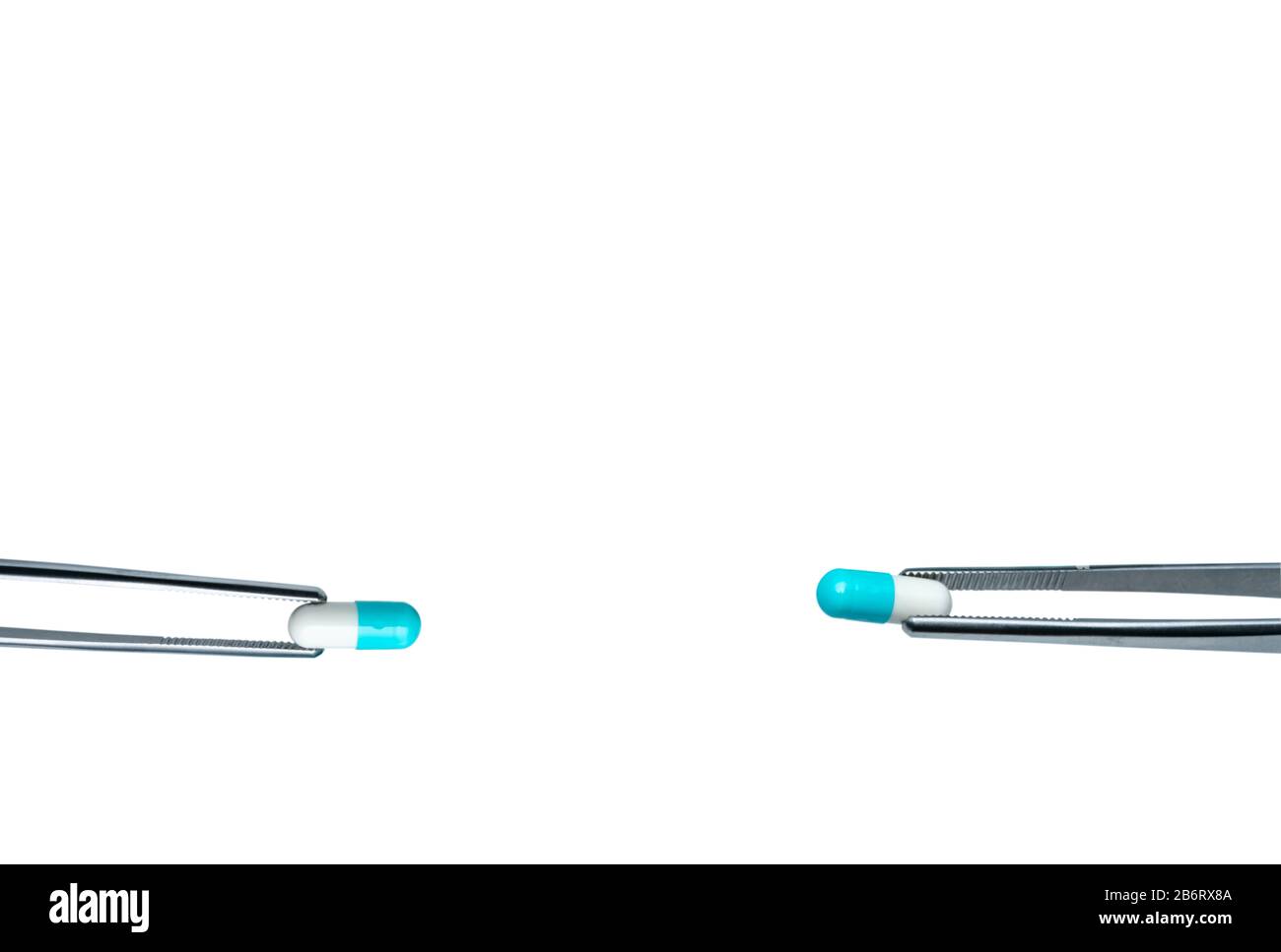 Two forceps pick white-blue capsule pills. Drugs choose for test in lab ...